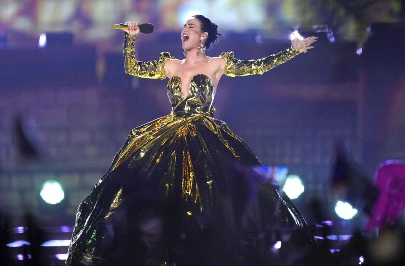 Katy Perry made a splash in a massive gold dress. she did not explain ...